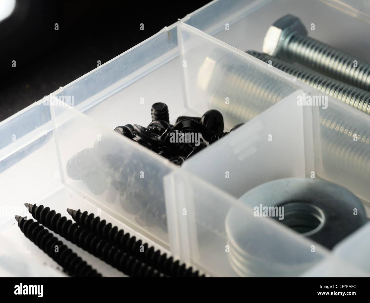 Closeup of various industrial fasteners in the plastic storage ...