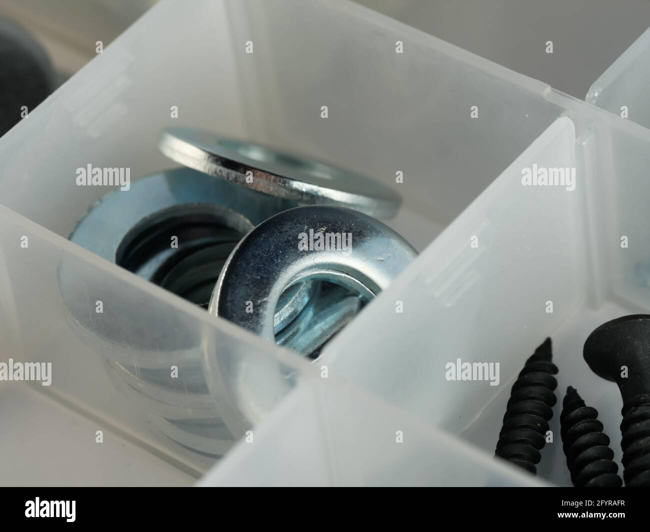 Closeup of various industrial fasteners in the plastic storage ...