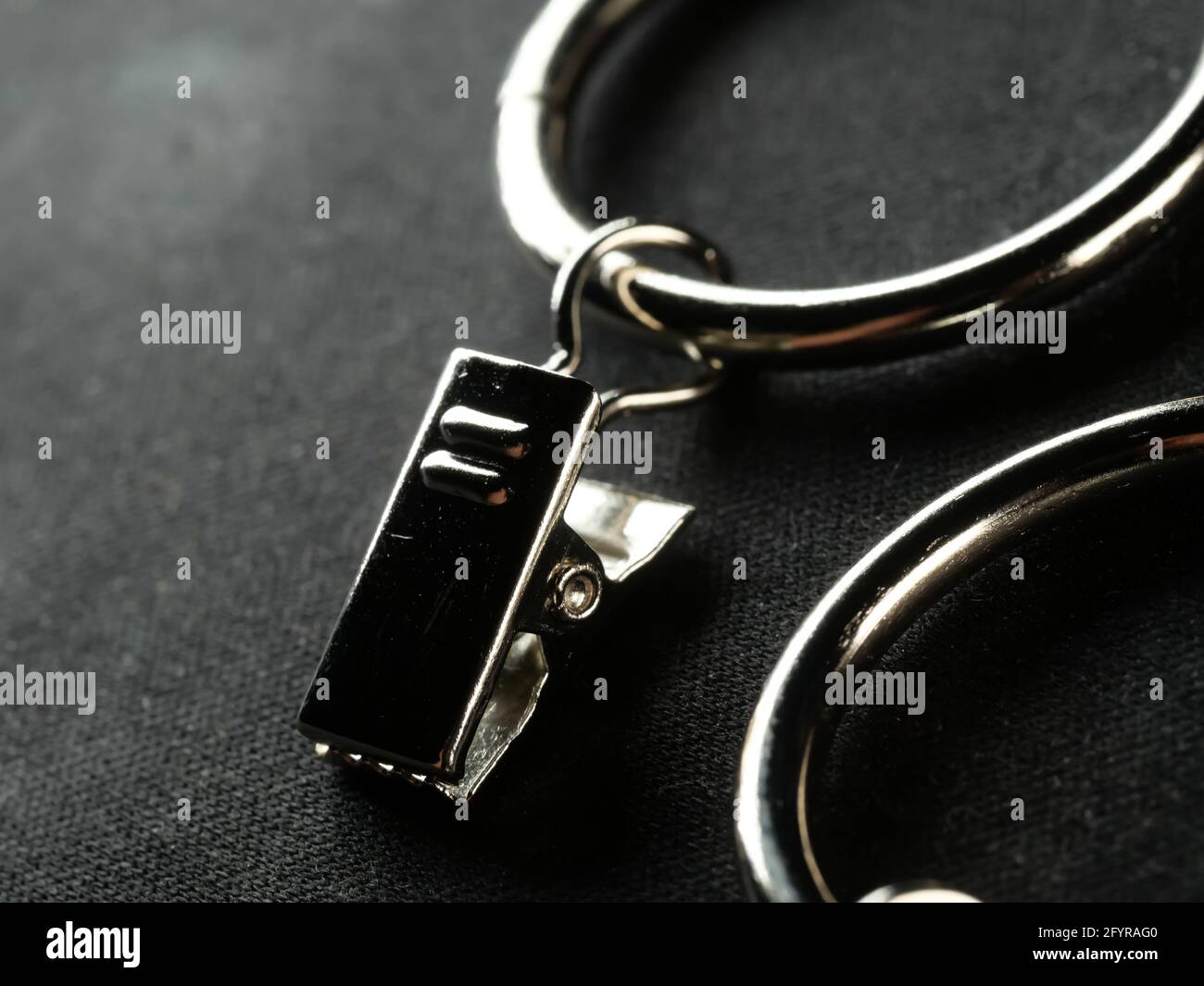 Dramatic grayscale shot of curtain metal rod clip rings Stock Photo - Alamy