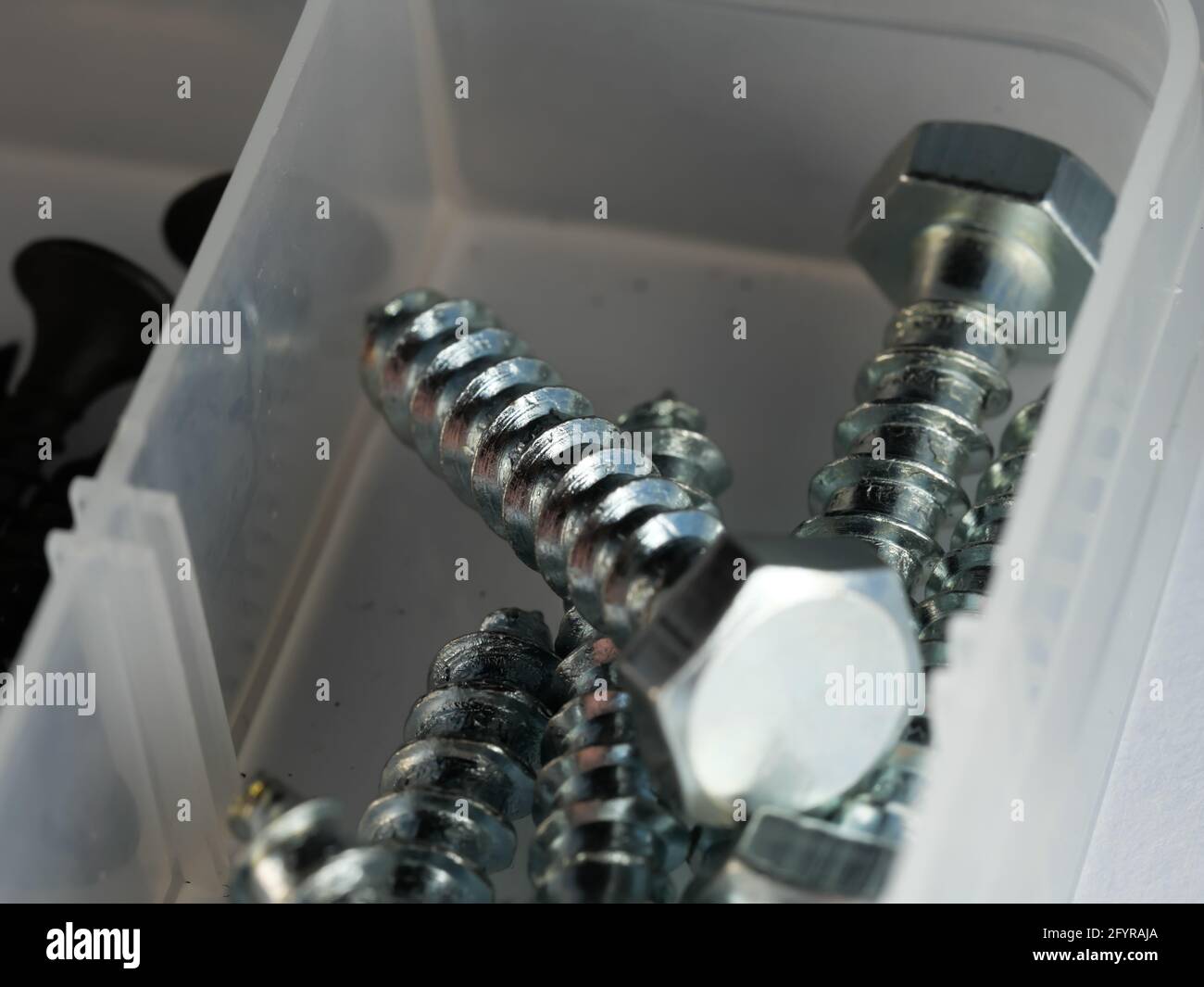 Closeup of hex bolts in the plastic storage container Stock Photo - Alamy