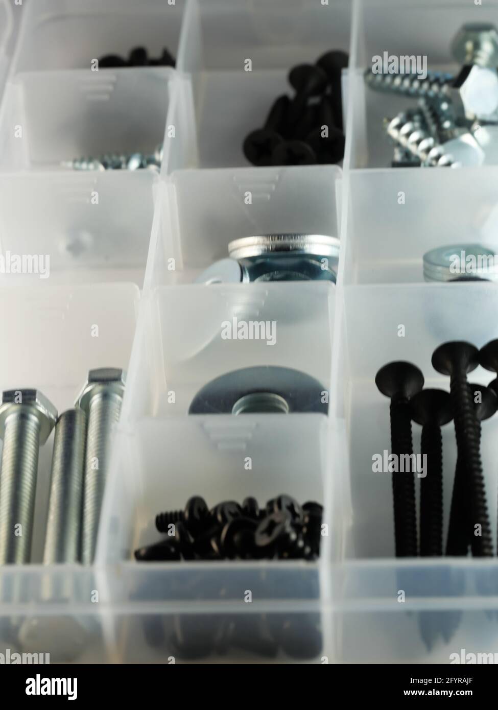 Closeup of various industrial fasteners in the plastic storage ...