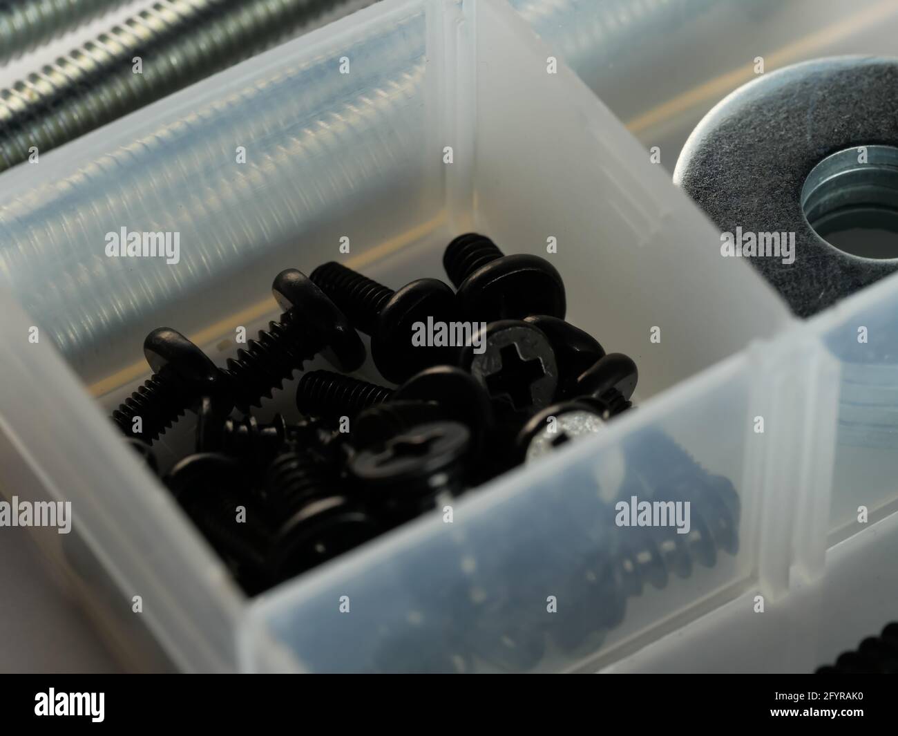 Closeup of various industrial fasteners in the plastic storage ...