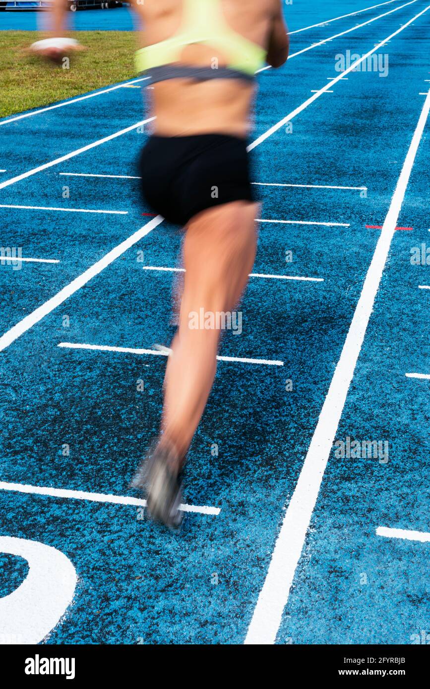 Crop woman athlete running on track Stock Photo - Alamy