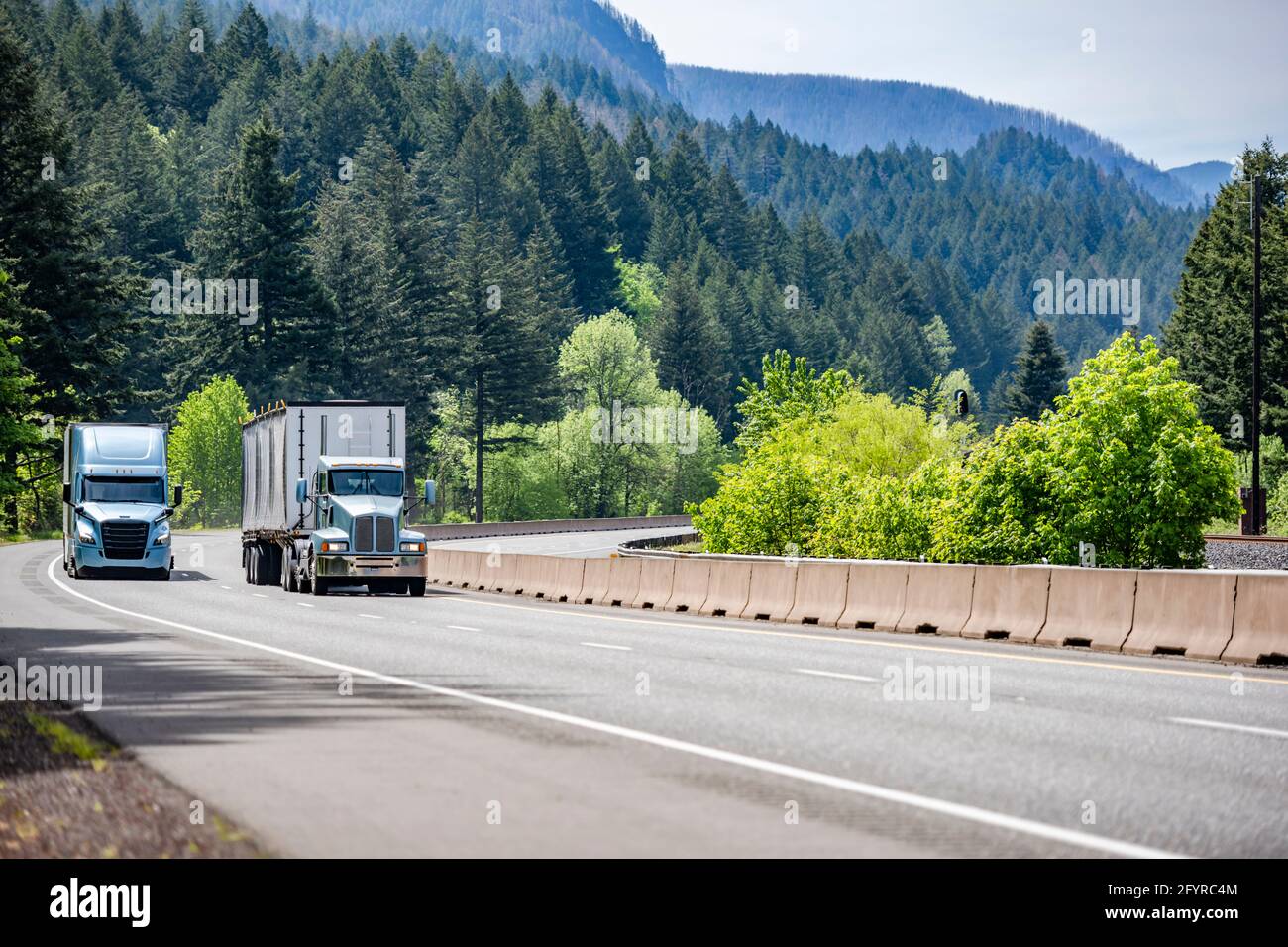 Two different big rig industrial semi truck tractors transporting ...