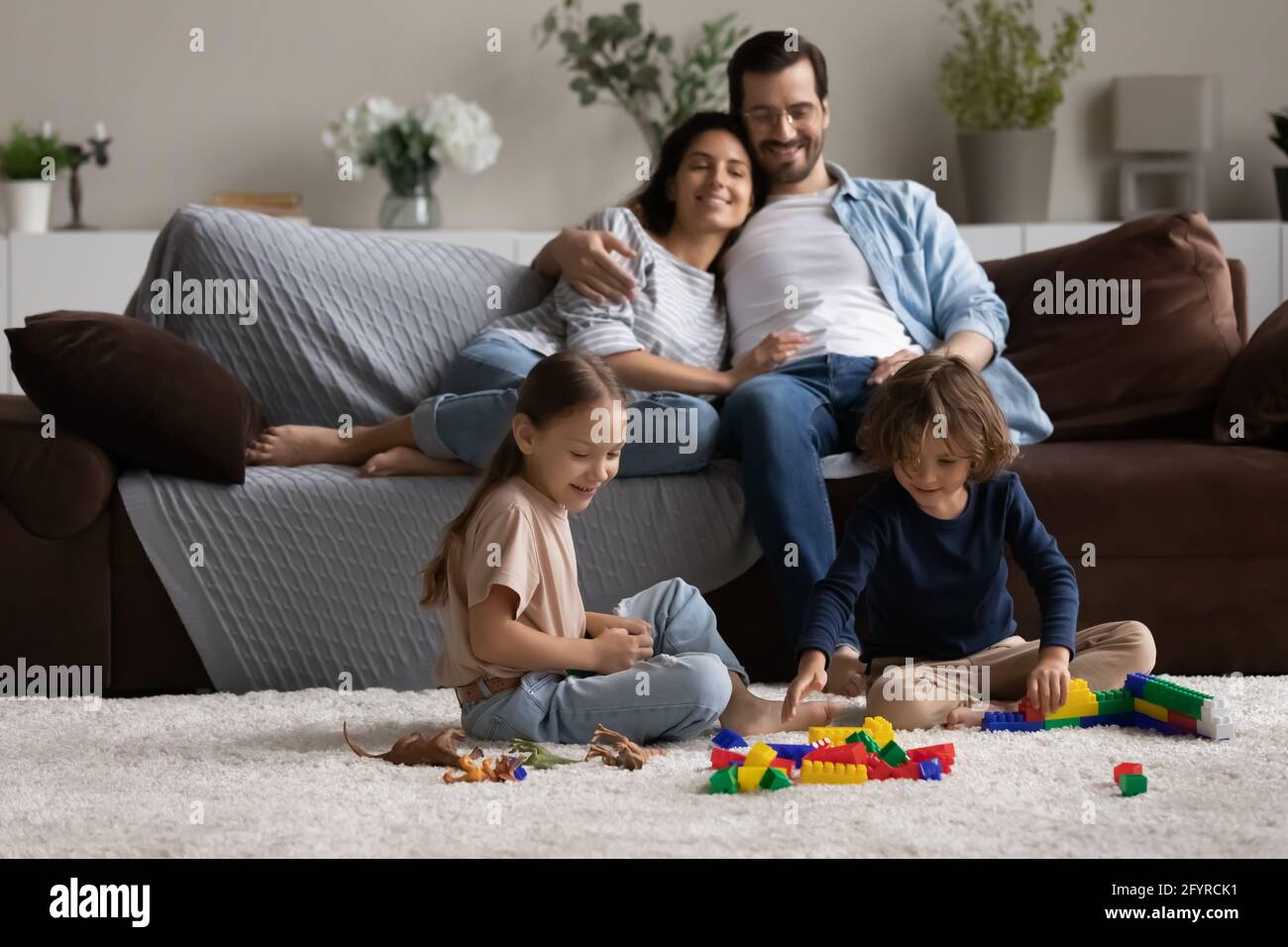 Happy family with kids relax at home on weekend Stock Photo - Alamy