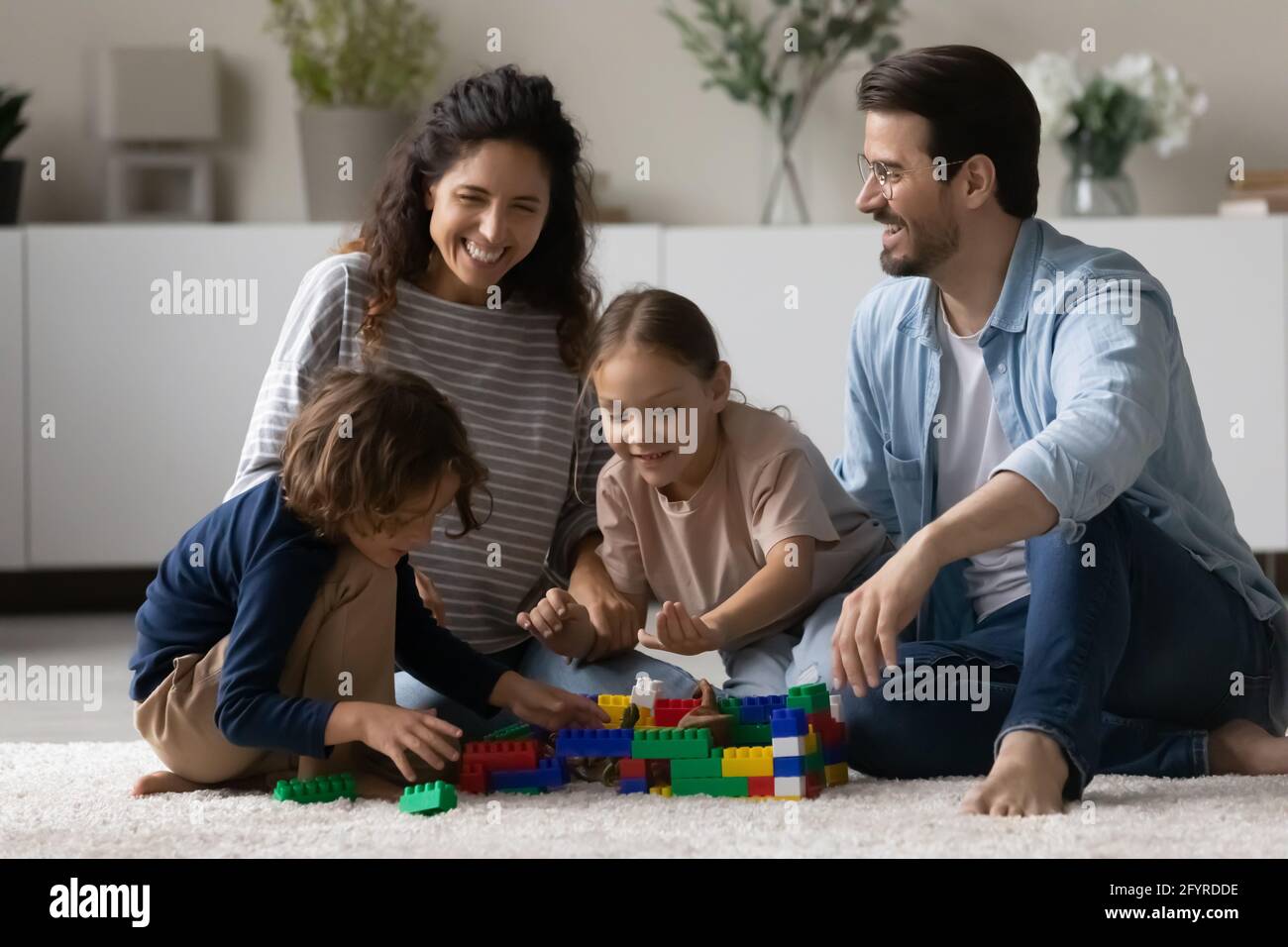 Happy multiracial family with kids play together Stock Photo - Alamy