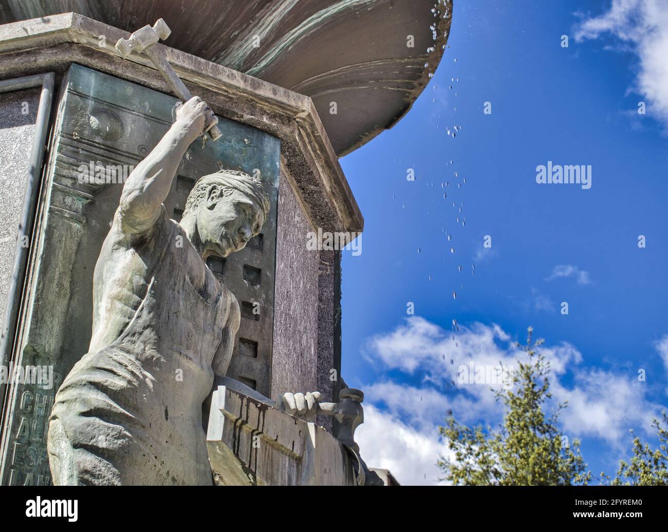 Statue of a blacksmith wielding a hammer on an anvil in the Golden ...