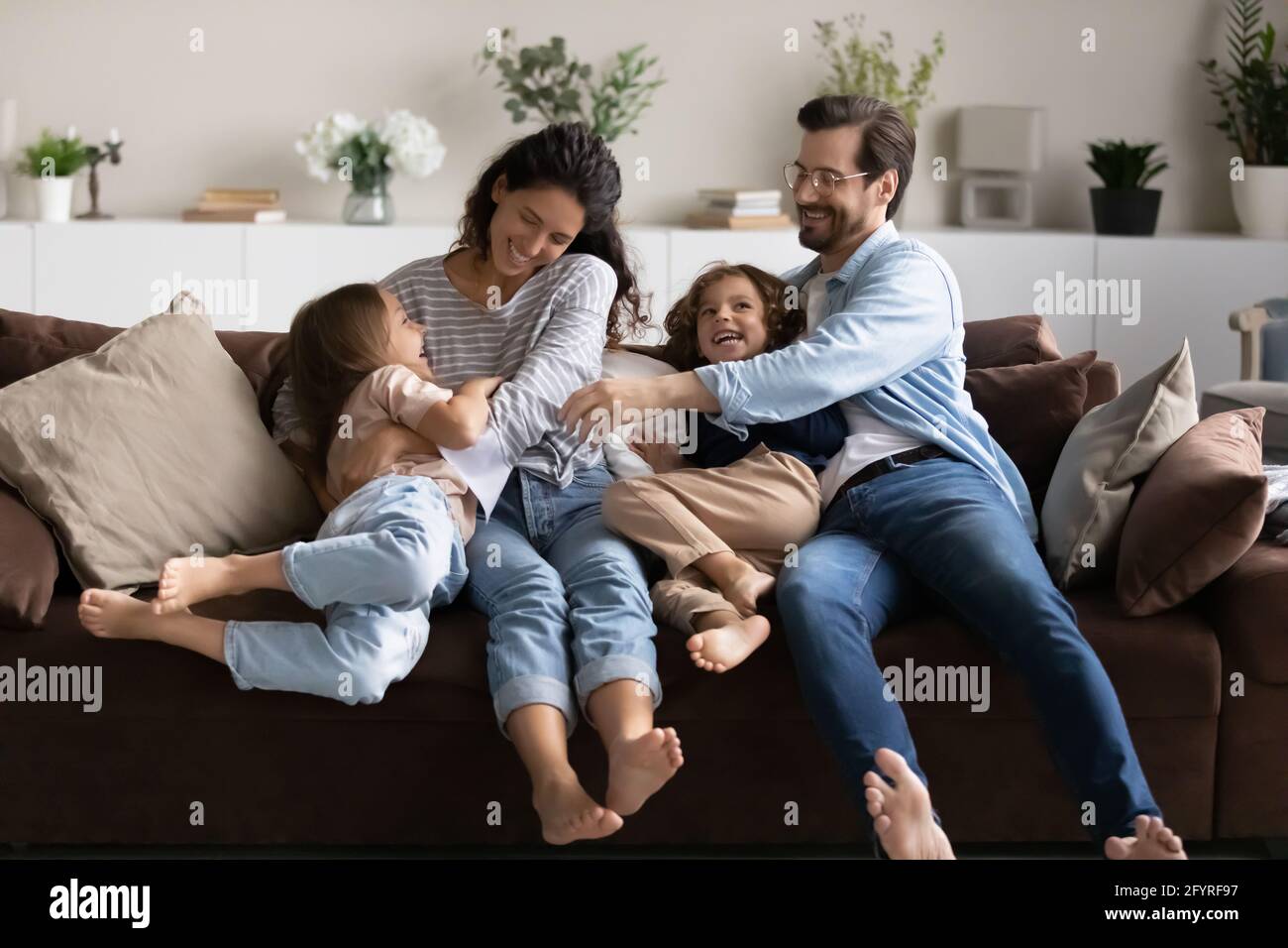 Overjoyed multiracial family with kids play at home Stock Photo - Alamy