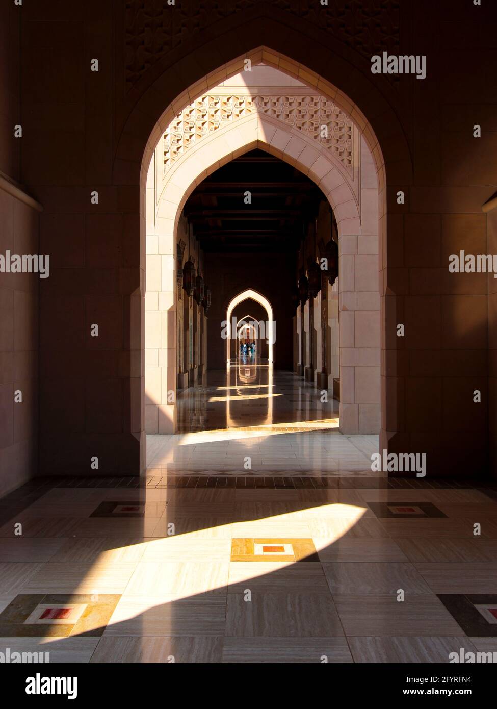 A shaded, arched arcade with sunlight showing through at the Sultan ...