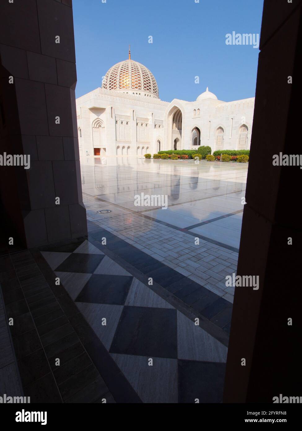 The main dome and sunny courtyard at the Sultan Qaboos Grand Mosque in ...