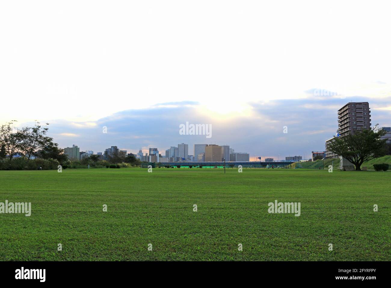 Scenery of a wide riverside river beach maintained in a sports field ...