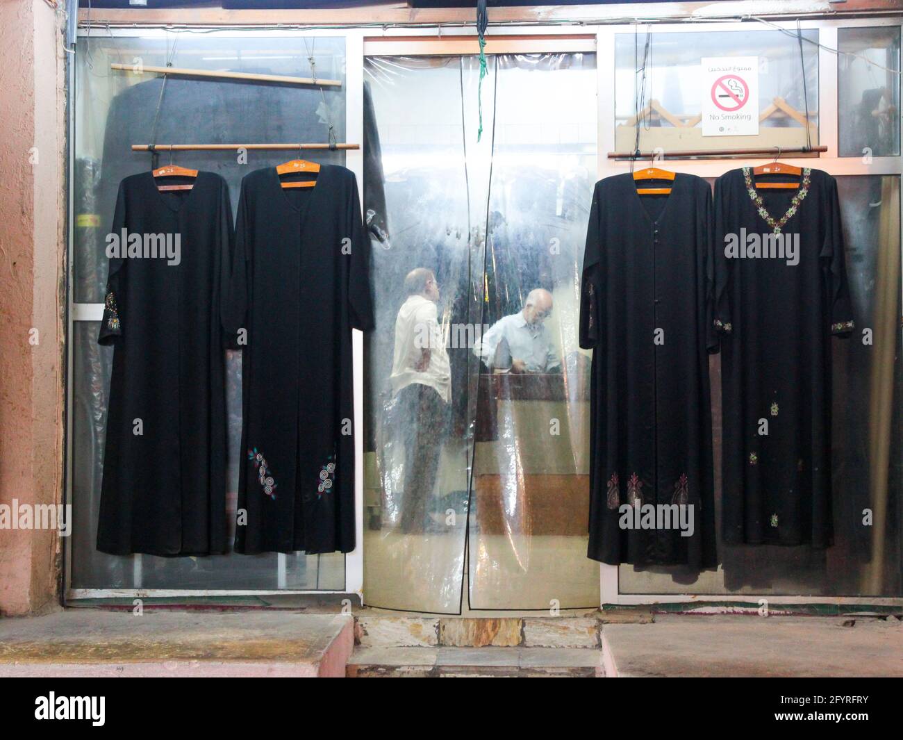 Traditional black Burqas hang outside a clothing shop at the famous ...