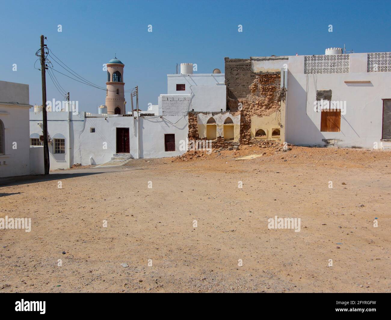The restored, round Al Ayjah Lighthouse and surrounding neighborhood of ...