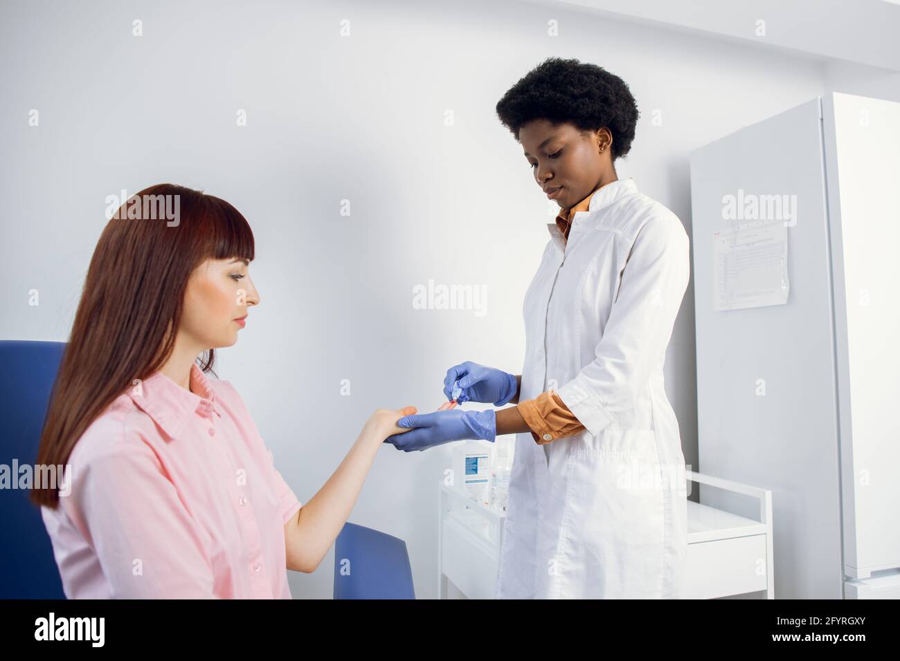 Doctor giving blood test finger hi-res stock photography and images - Alamy