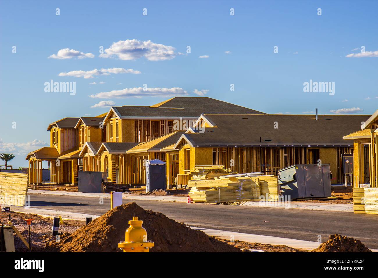 Row Of New Homes Under Construction In Late Afternoon Stock Photo - Alamy