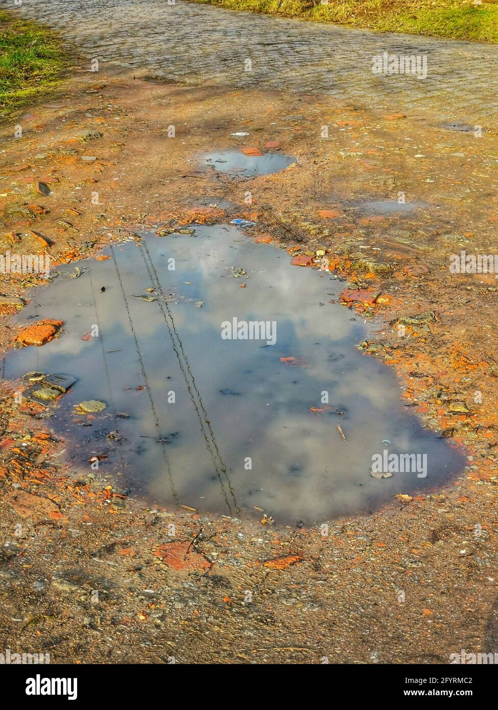 Puddle on asphalt after the rain Stock Photo - Alamy