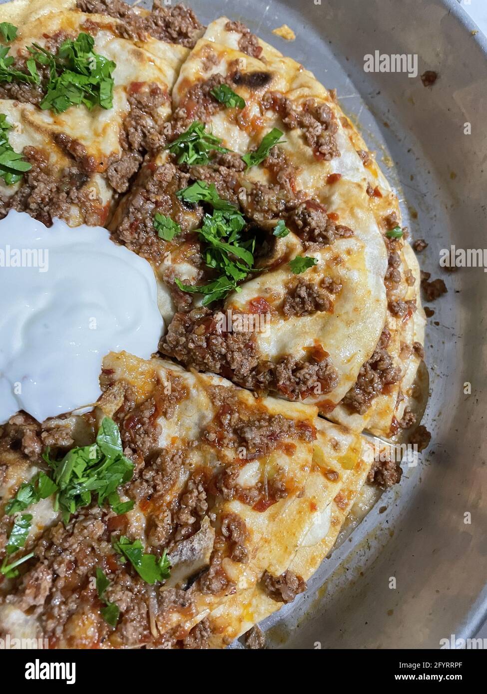 A top view of a creamy Pizza with ground minced meat and white sauce ...
