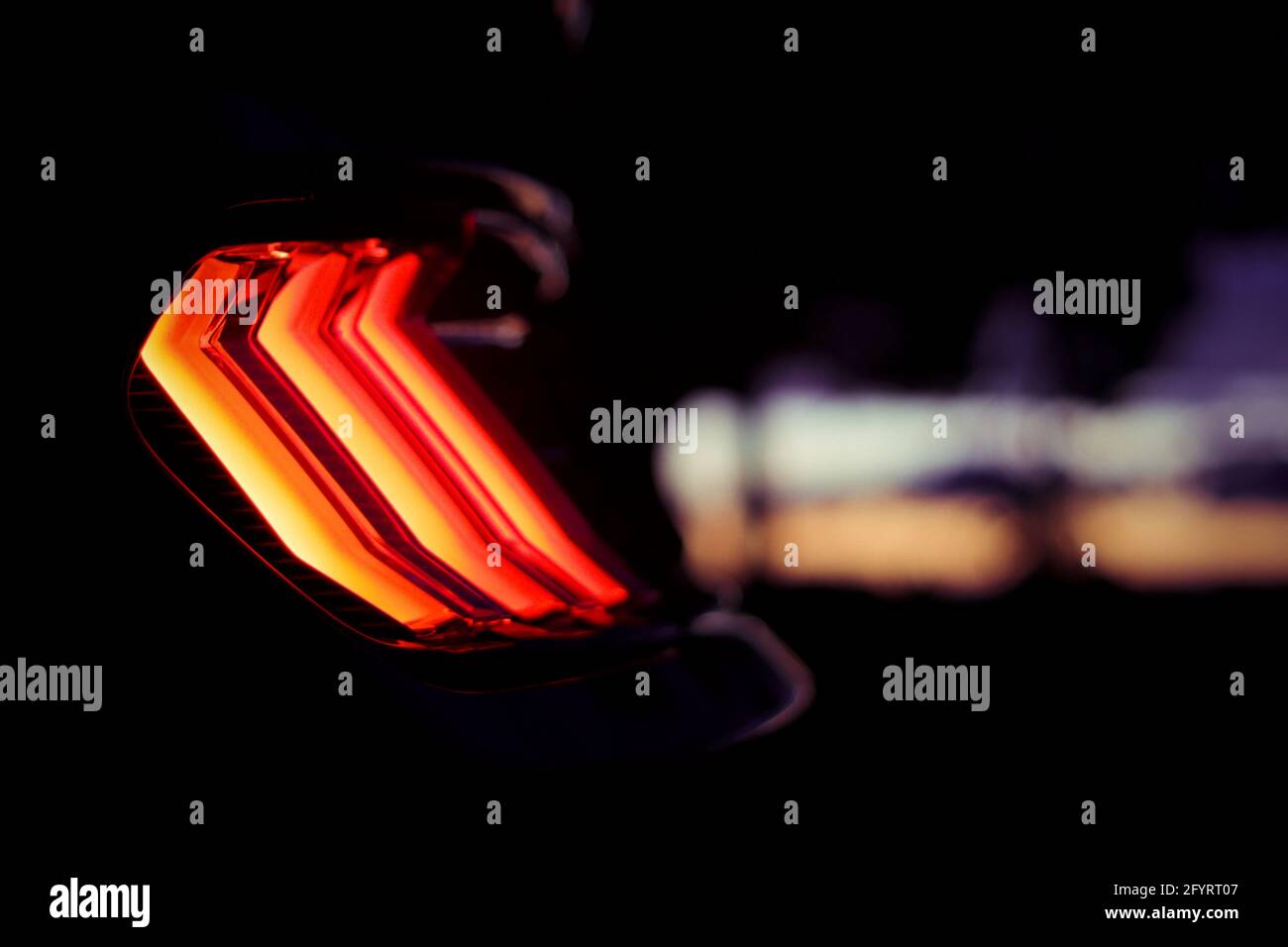 A closeup shot of a black sports car red backlight at night Stock Photo ...