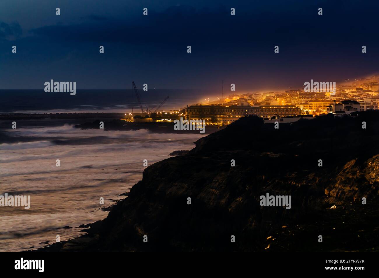 A beautiful lights from urban buildings on the coastal city at night ...