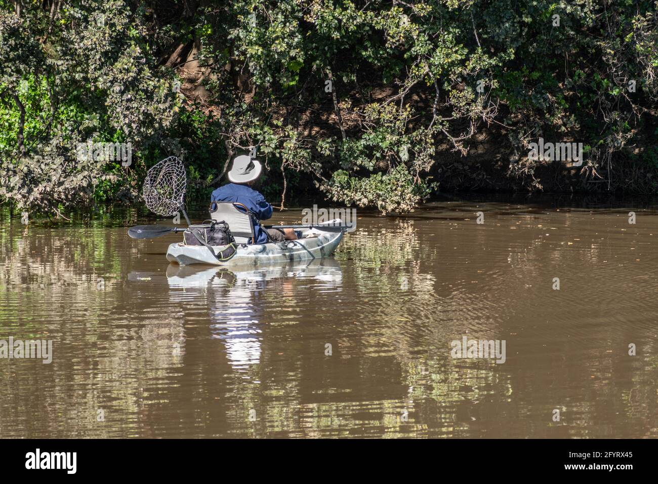 A man fishes from a fishing kayak on the Caboolture River in Caboolture ...