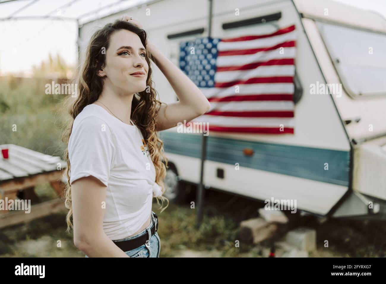 A beautiful Spanish female posing on background of the US flag - US ...
