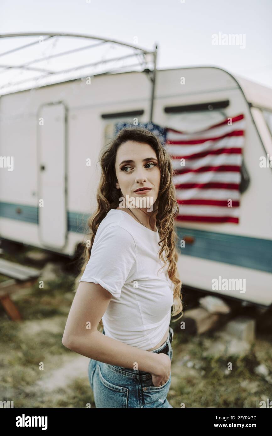 A beautiful Spanish female posing on background of the US flag - US ...