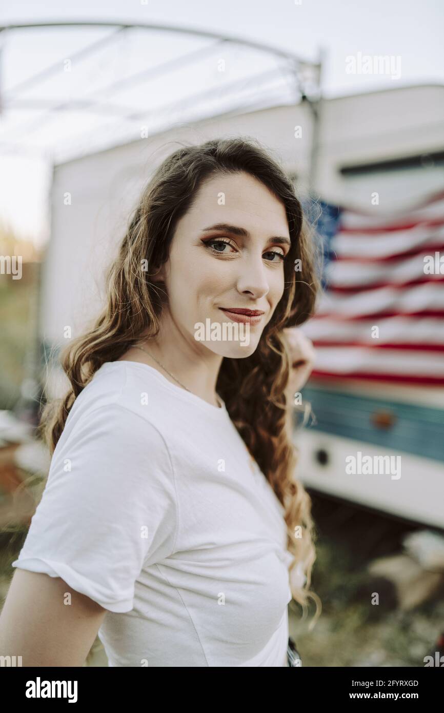 A beautiful Spanish female posing on background of the US flag - US ...