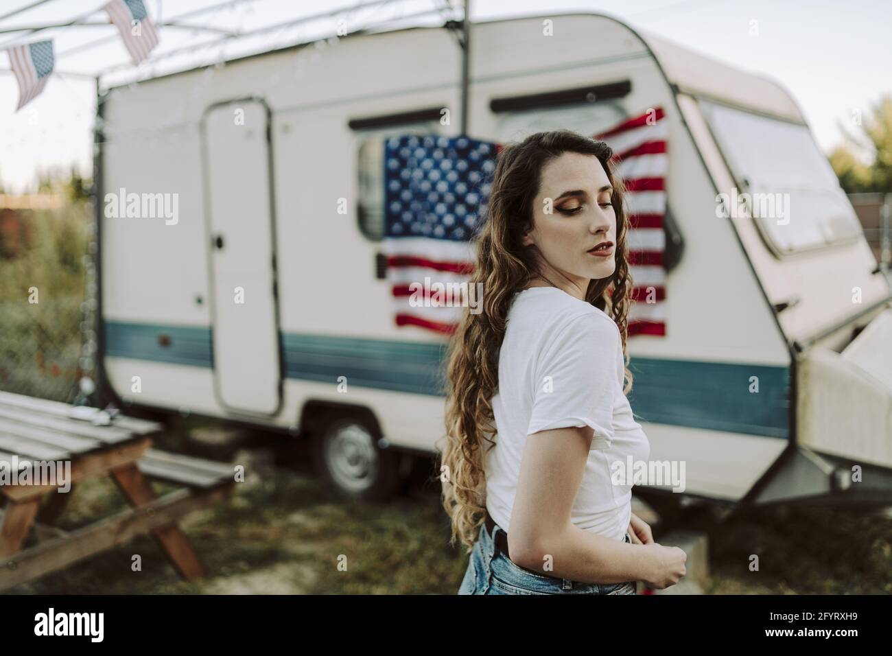 A beautiful Spanish female posing on background of the US flag - US ...