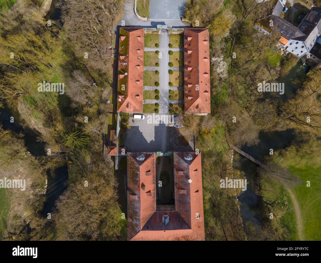 An aerial view of a medieval castle with red rooftops surrounded by ...