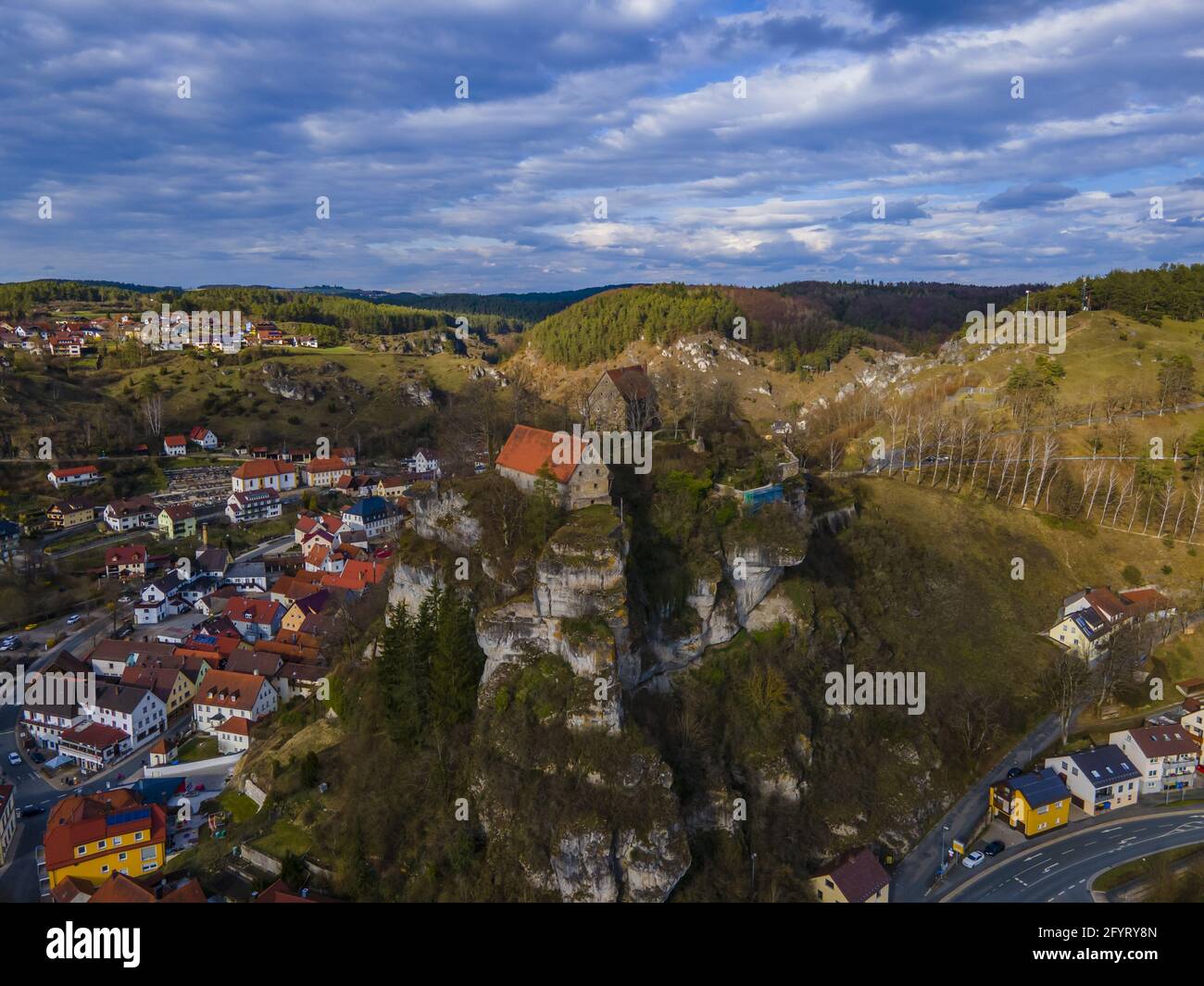 An eerie scenery of an ancient medieval fortress on the hill above a ...