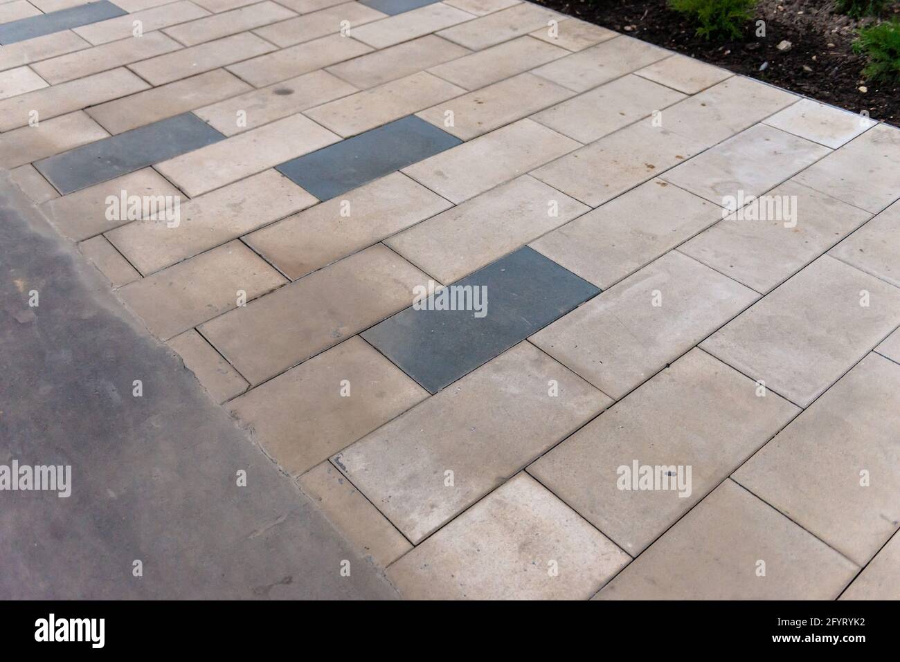 Tile and asphalt combination in the yard. Two paths made of different ...