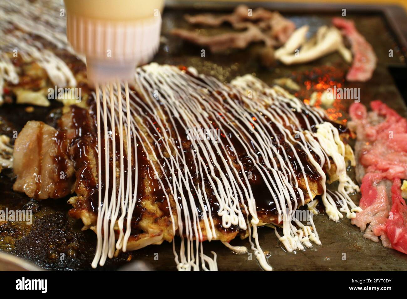 Okonomiyaki, Osaka's famed cabbage pancake Stock Photo - Alamy
