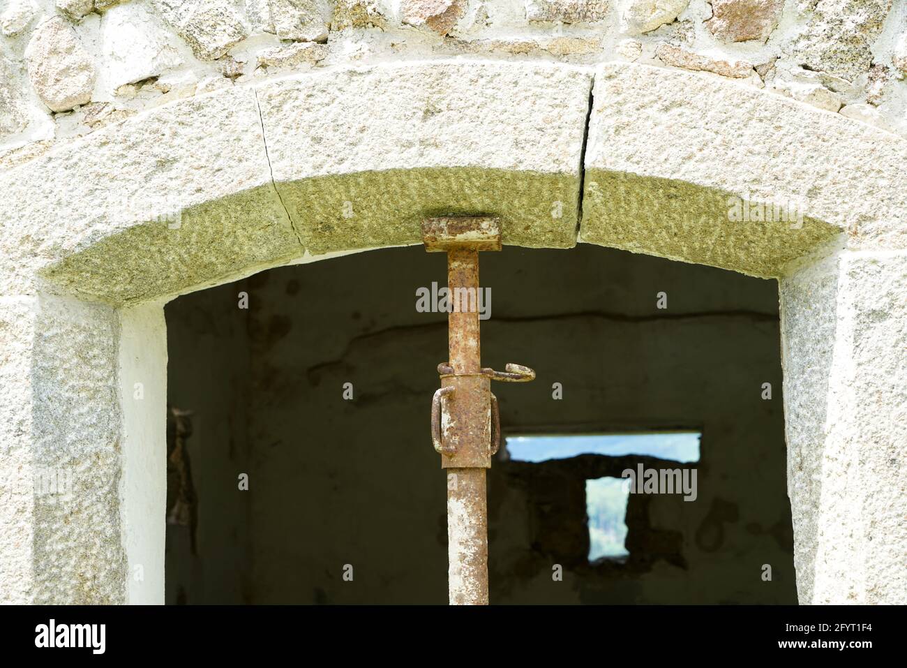A rusty pipe running through an old window frame in a brick wall Stock ...