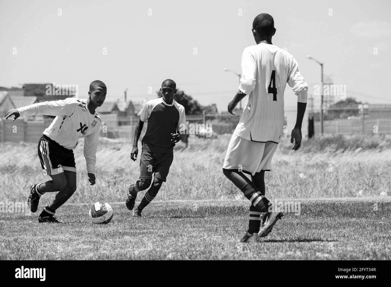Children playing soccer field Black and White Stock Photos & Images - Alamy