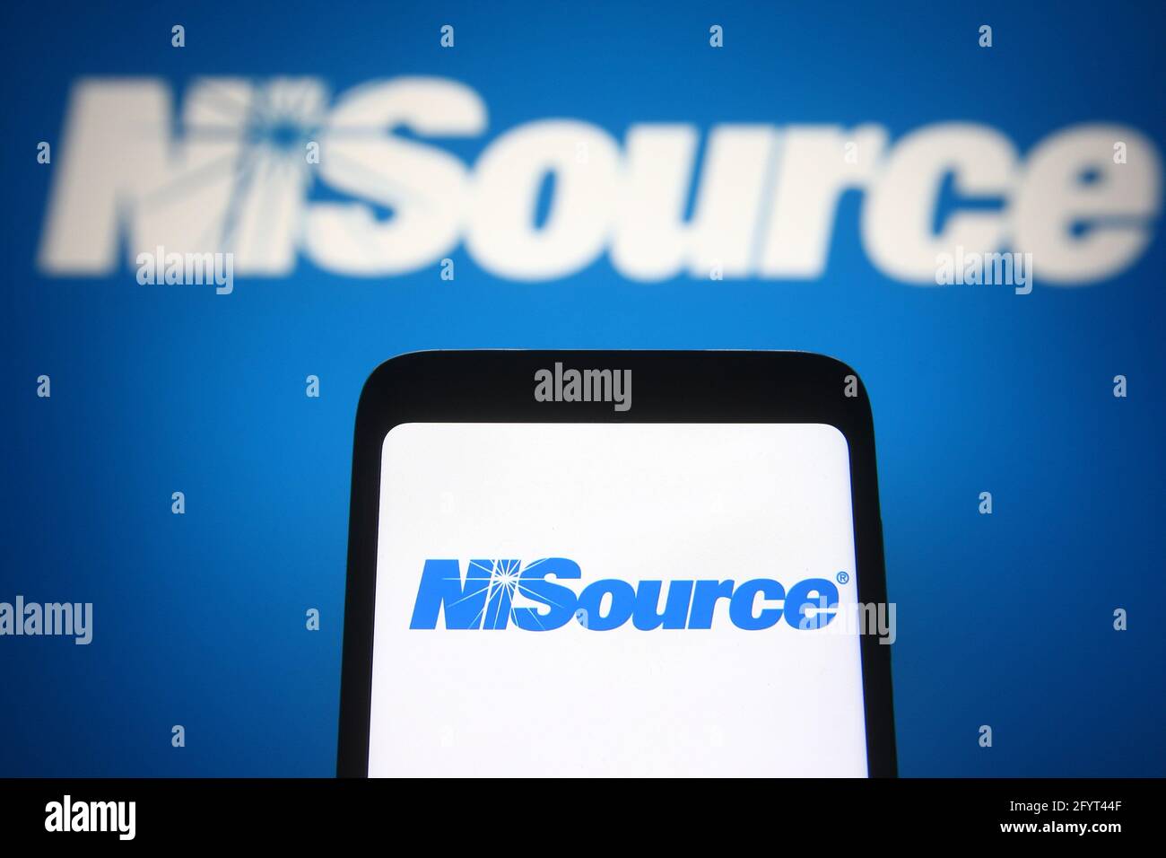 In this photo illustration, NiSource logo seen on a smartphone and a pc ...