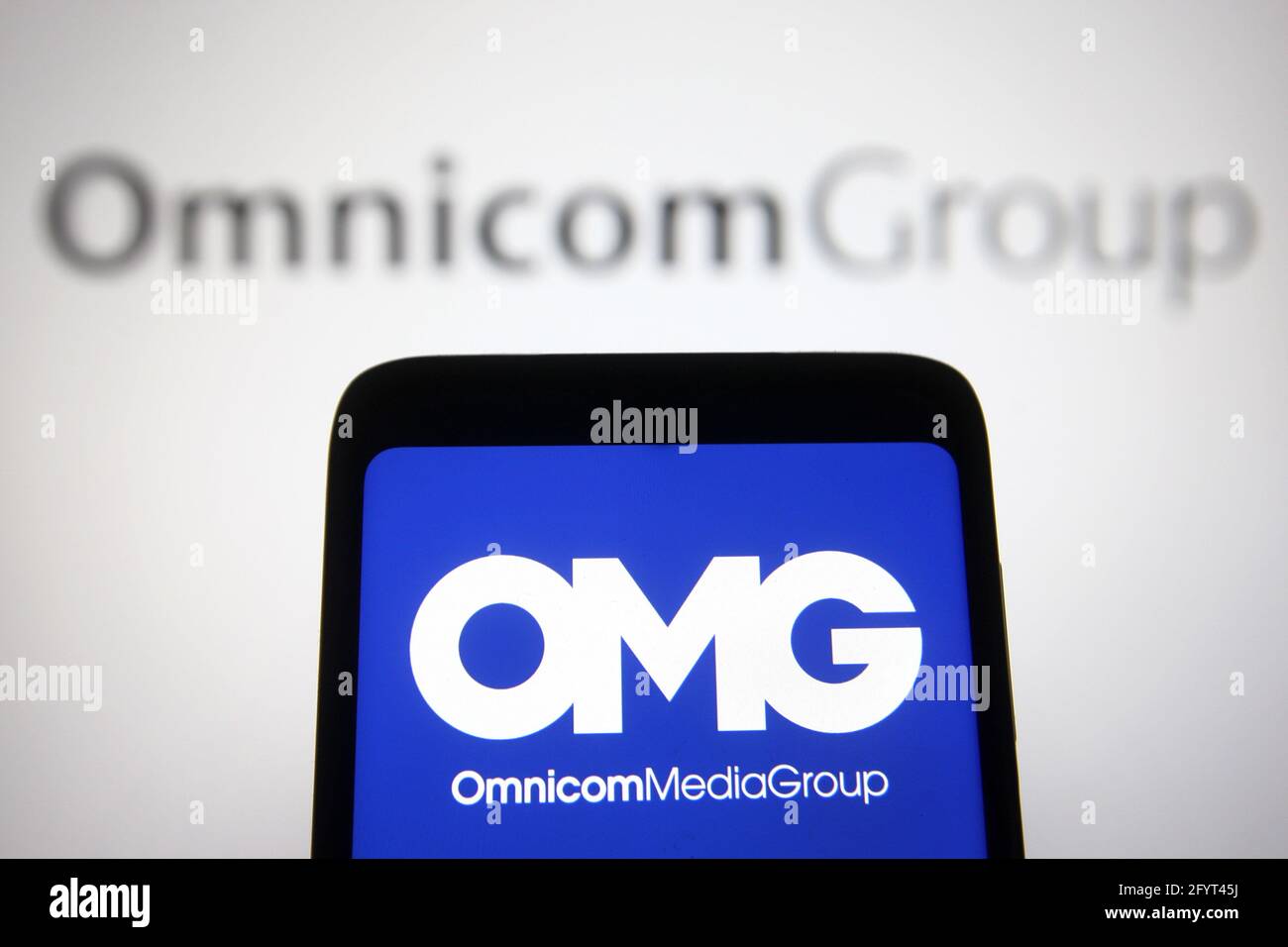 In this photo illustration, Omnicom Group logo seen on a smartphone and ...