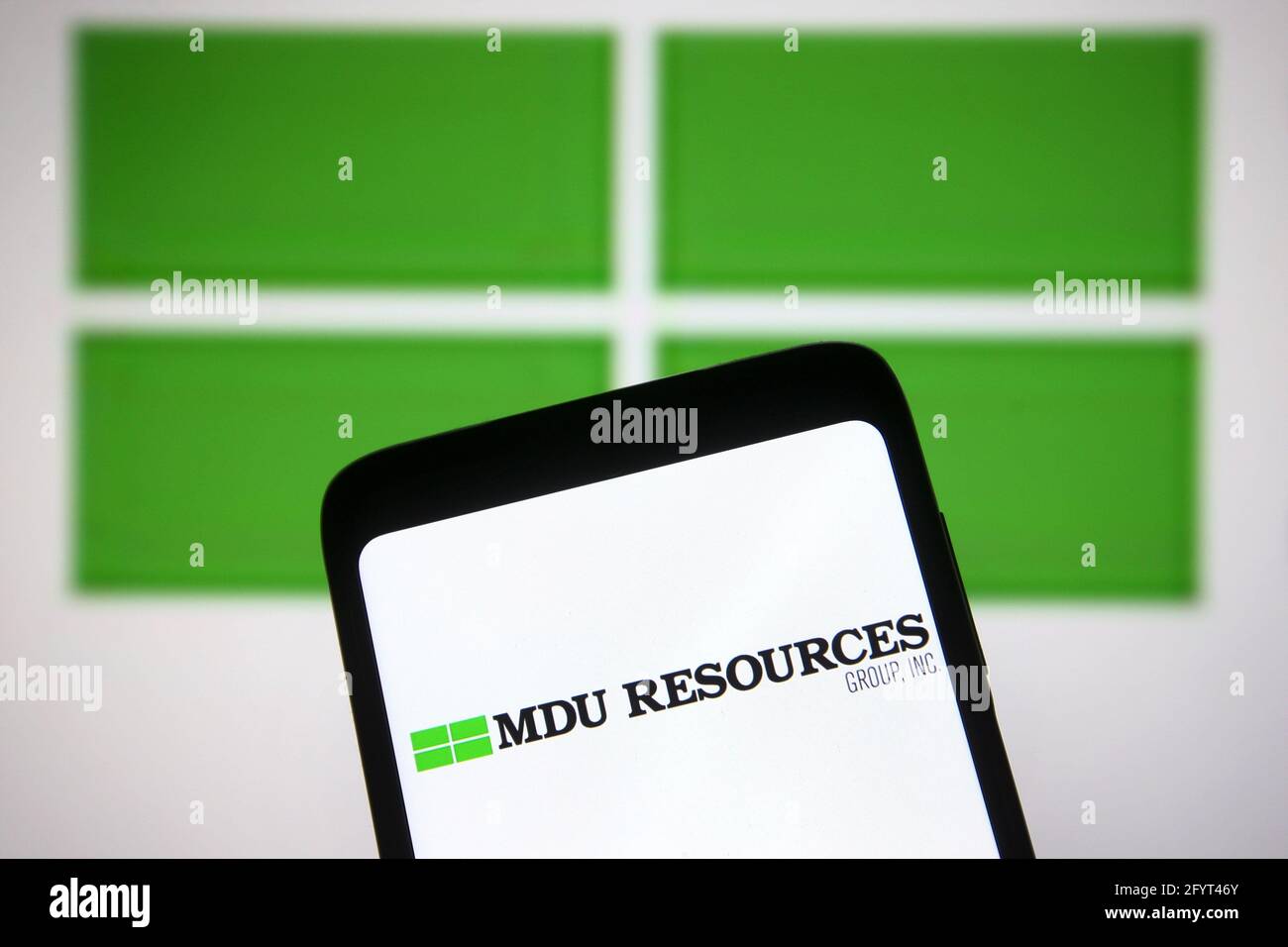 In this photo illustration, MDU Resources logo seen on a smartphone and ...