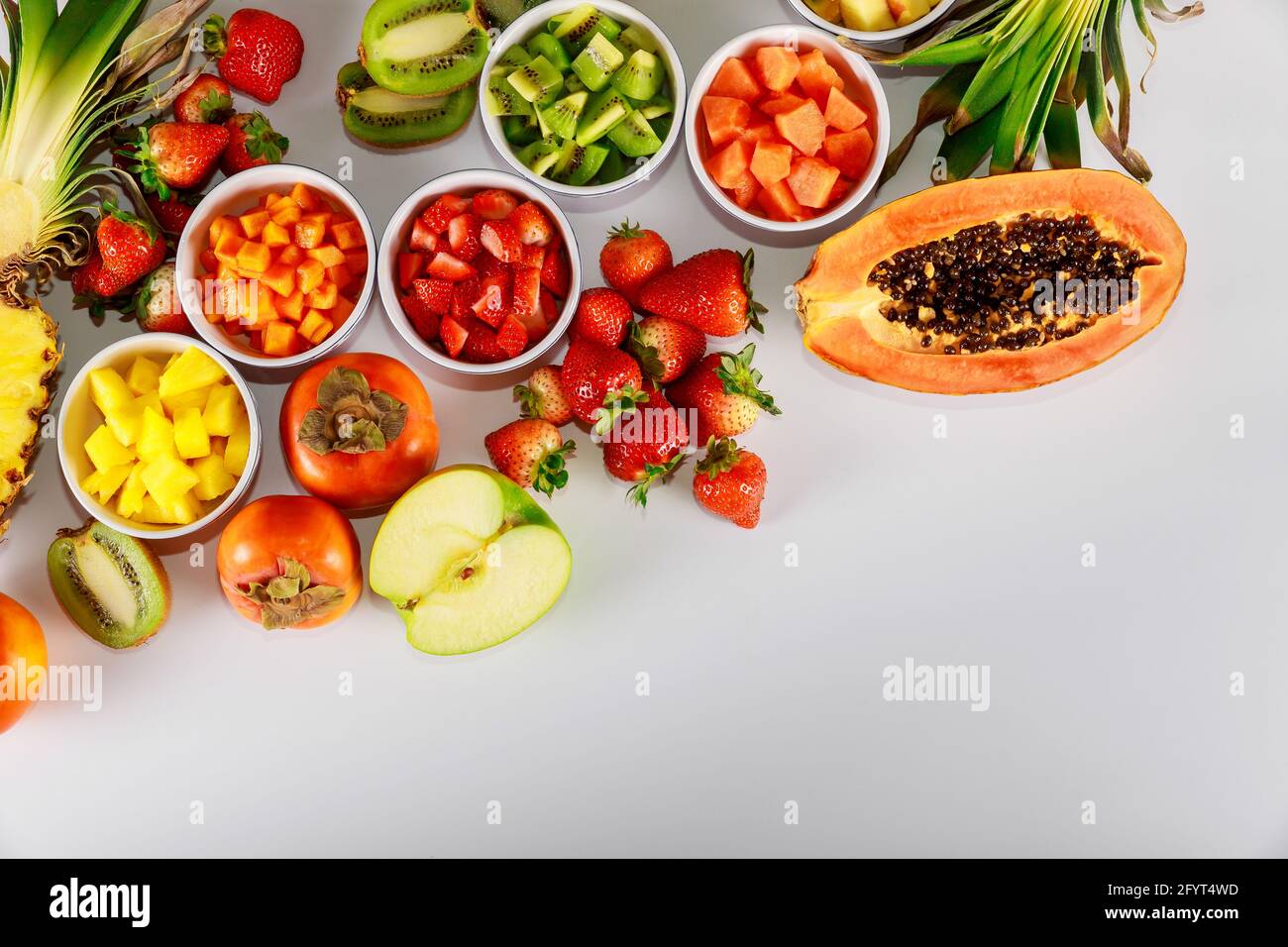 Tropical colorful whole and cut fruits on white background Stock Photo ...