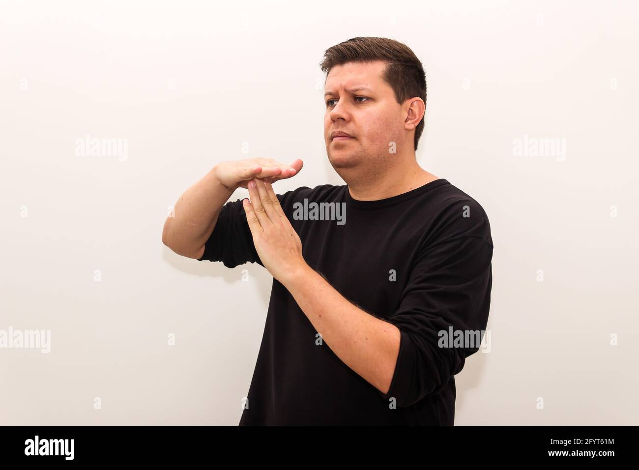 A Caucasian male showing time out sign with hands Stock Photo - Alamy