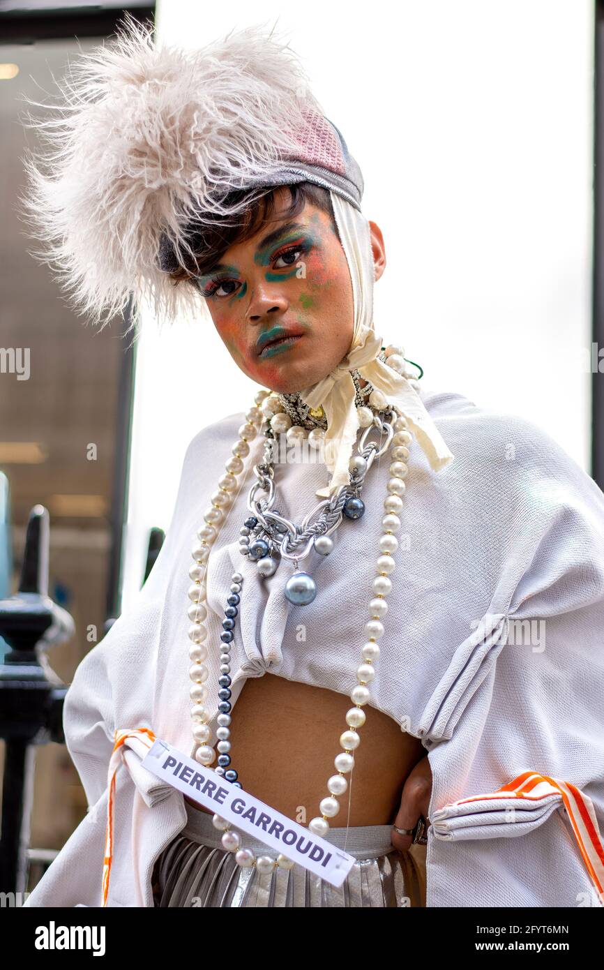 A model showcases Pierre Garroudi's latest colourful collection at one ...