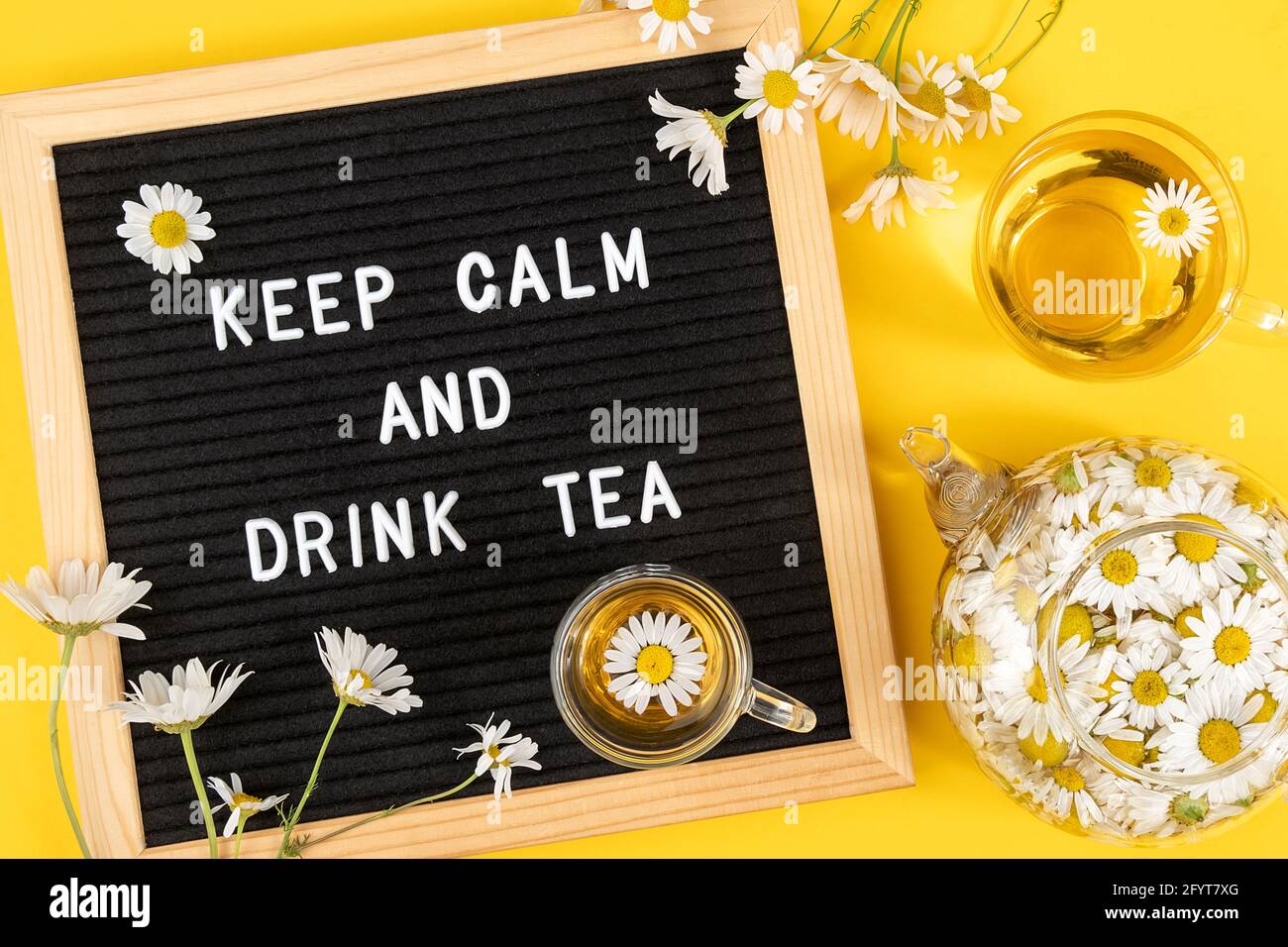 Keep calm and drink tea. Motivational quote on black letter board and ...