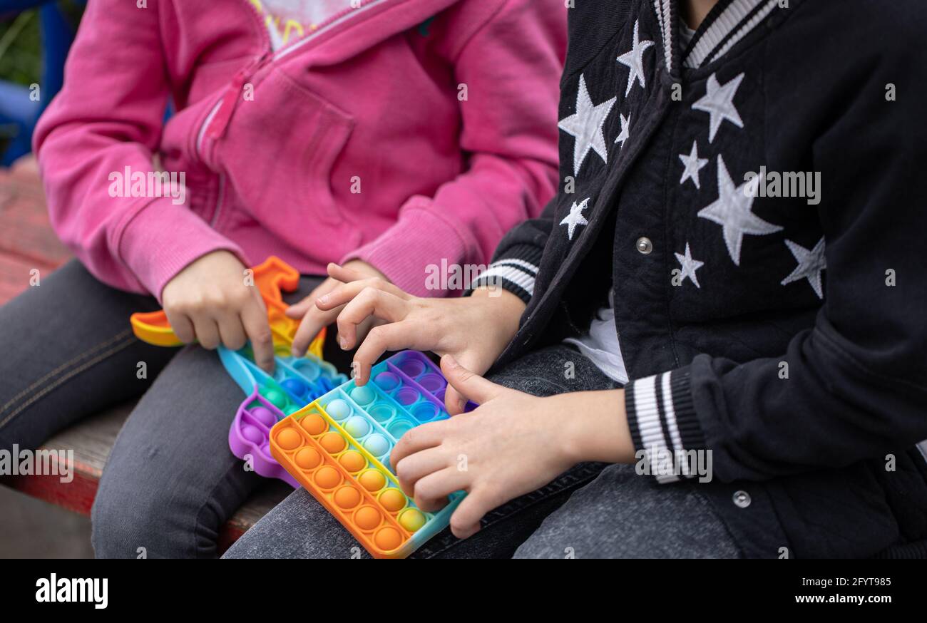 Little girls playing a new fidget toy popular with children helps them ...