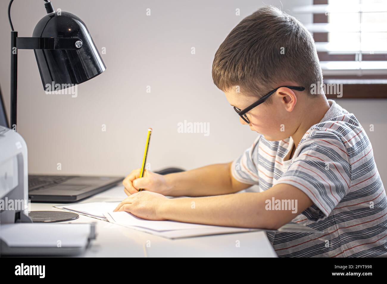 An elementary school student does his homework on his own Stock Photo ...