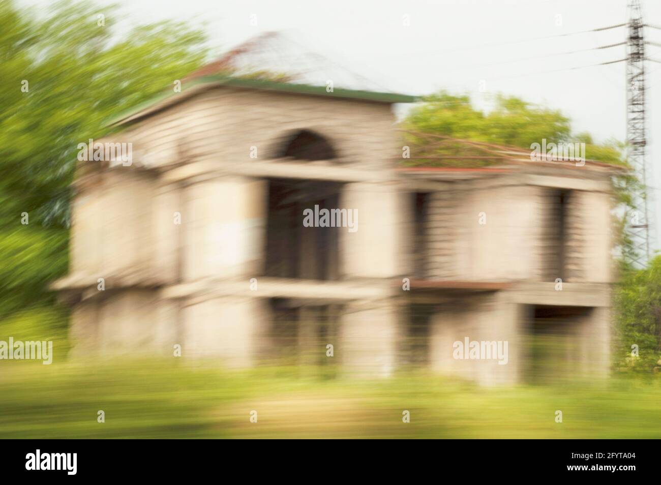 A motion blur image of an unfinished and abandoned roadside building ...