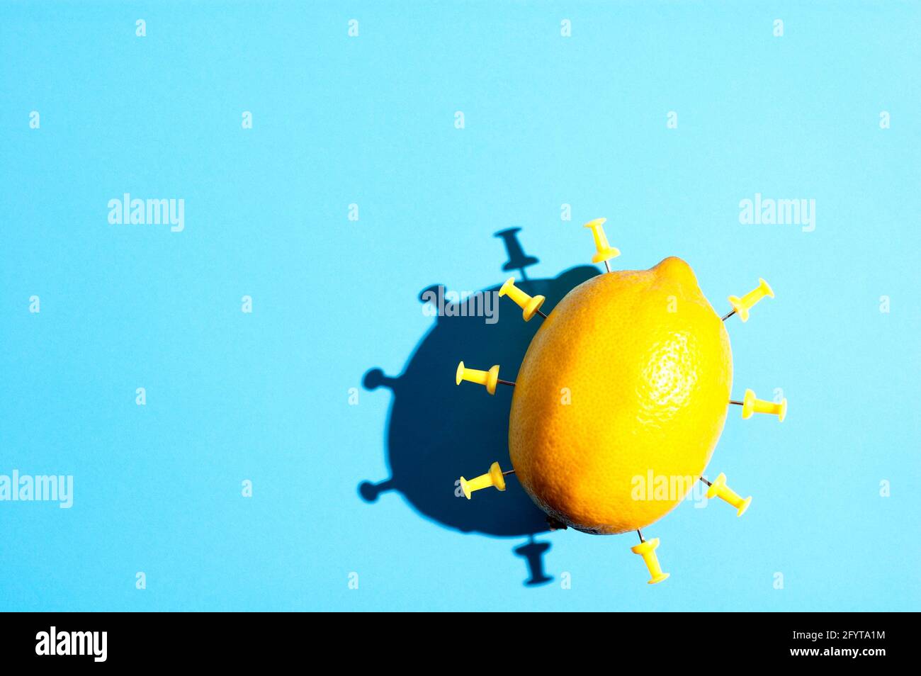 A simple creative object made of lemon and paper pins. Minimalist ...