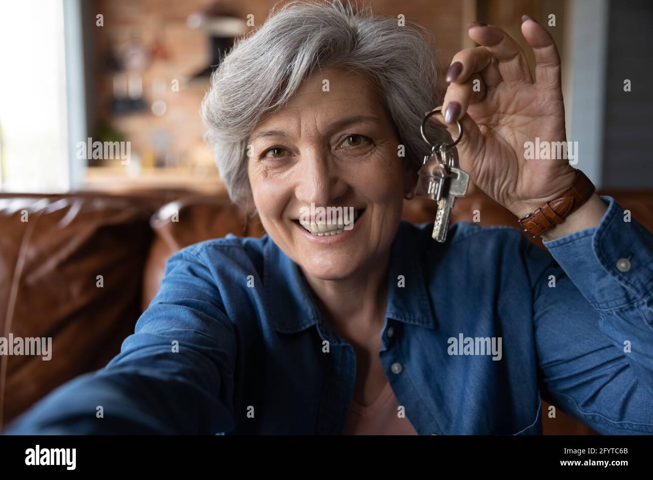 Happy mature woman showing keys from new house Stock Photo - Alamy