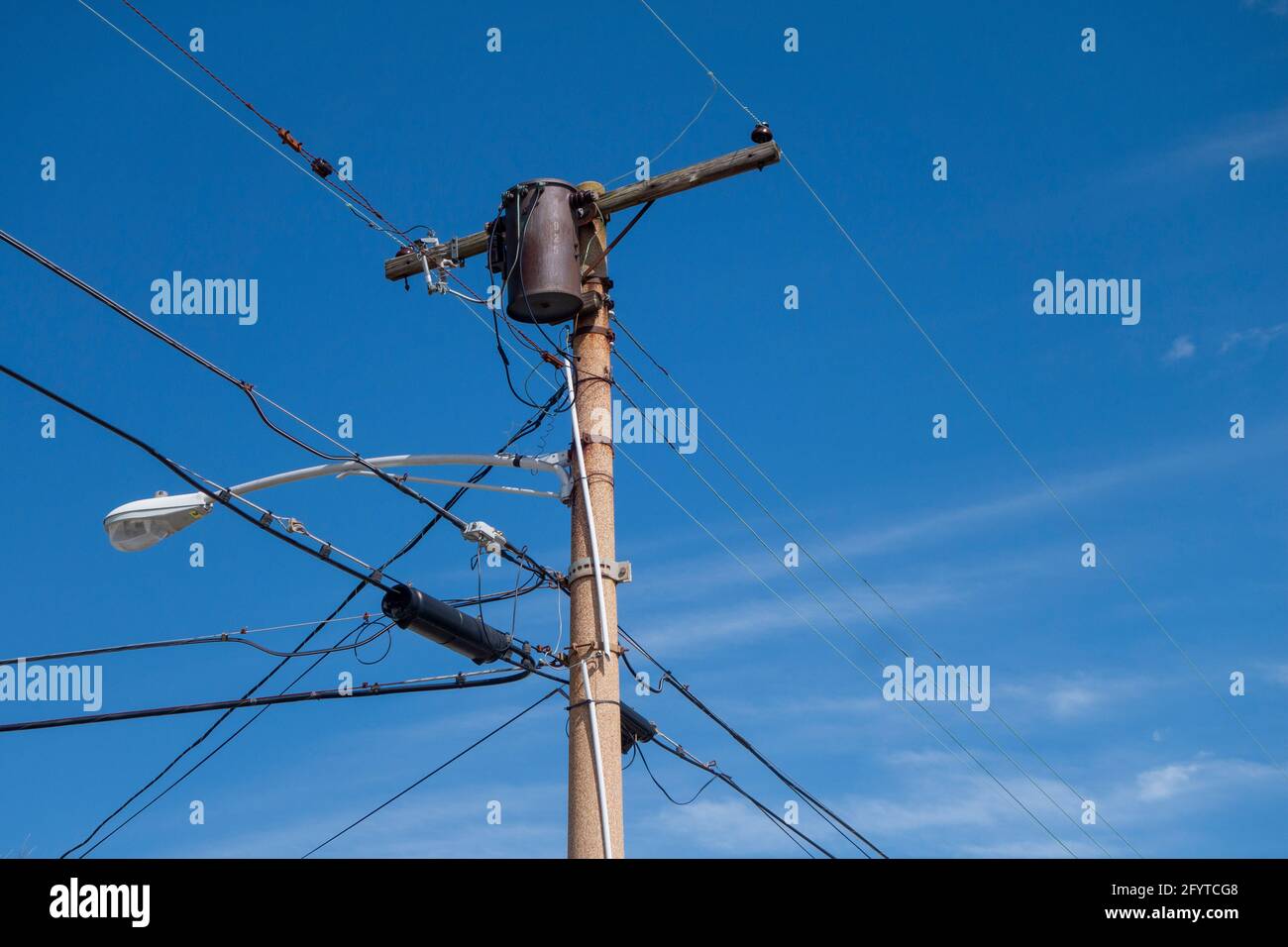 Utility pole supporting wires for electrical power distribution ...
