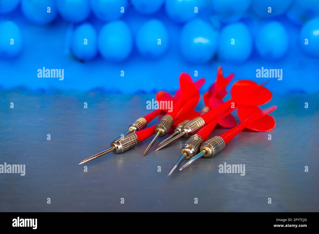 pop a ballon on this wall of ballons with darts Stock Photo - Alamy