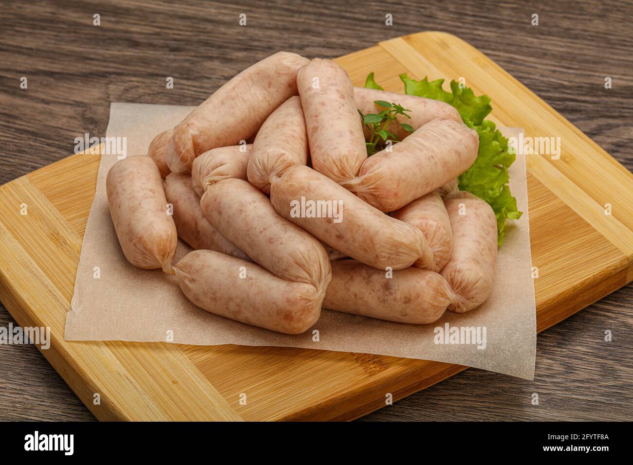Raw natural chicken baby sausages for roast Stock Photo - Alamy