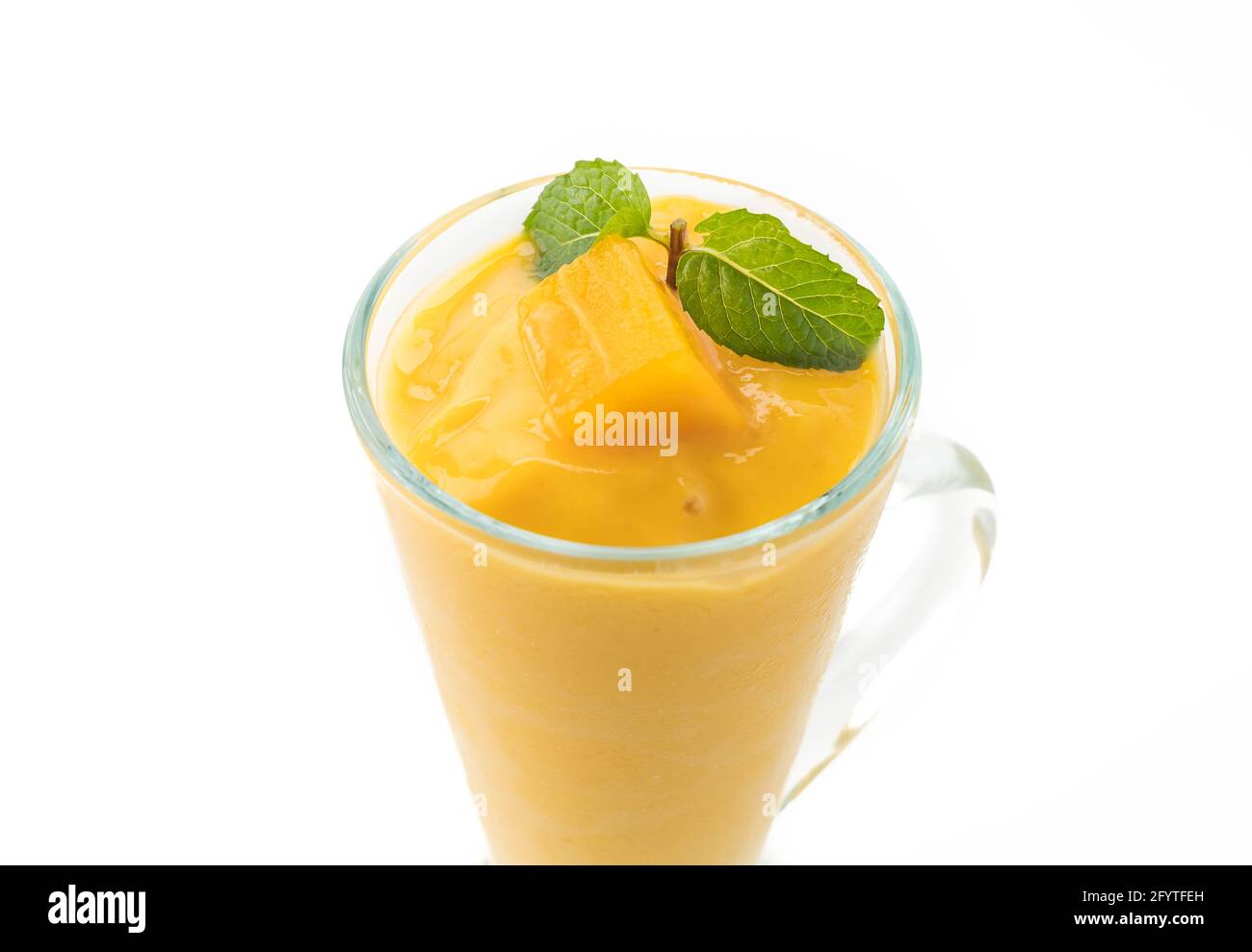 fresh mango smoothie on white background Stock Photo - Alamy